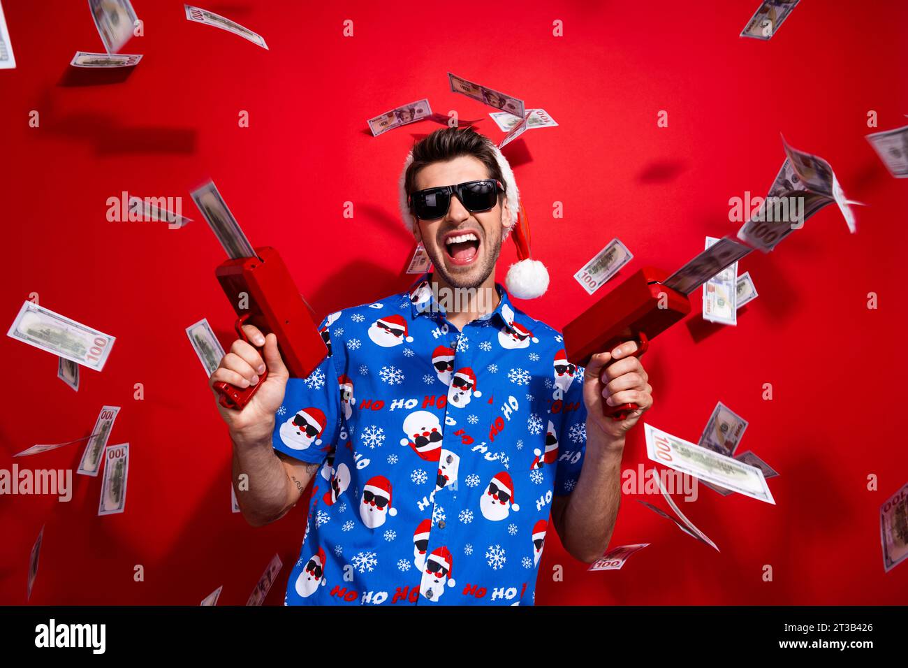 Photo of successful rich young guy shooting money gun usd bills ...