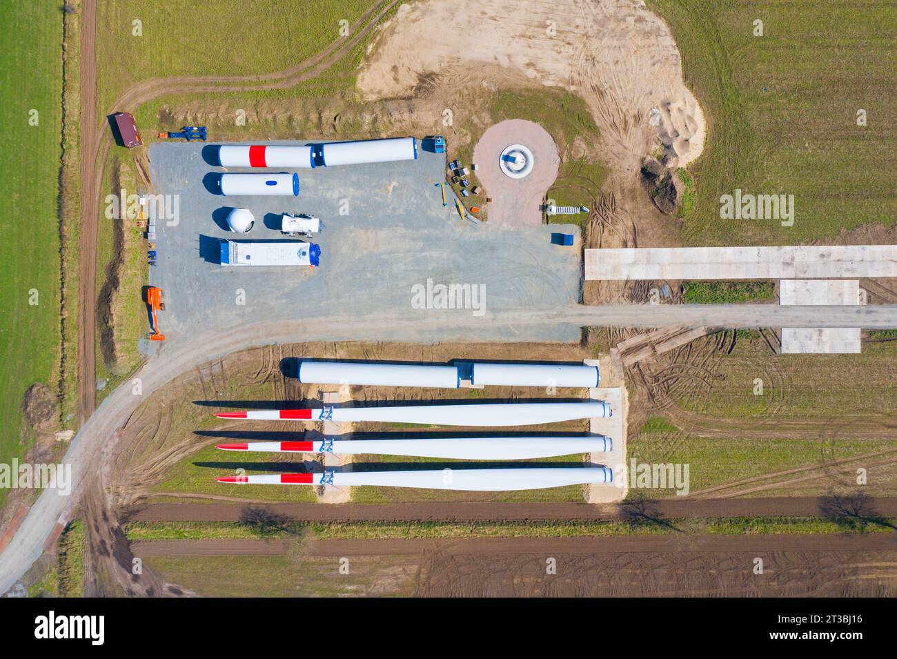 Aerial view over construction site showing wind turbine parts like huge ...