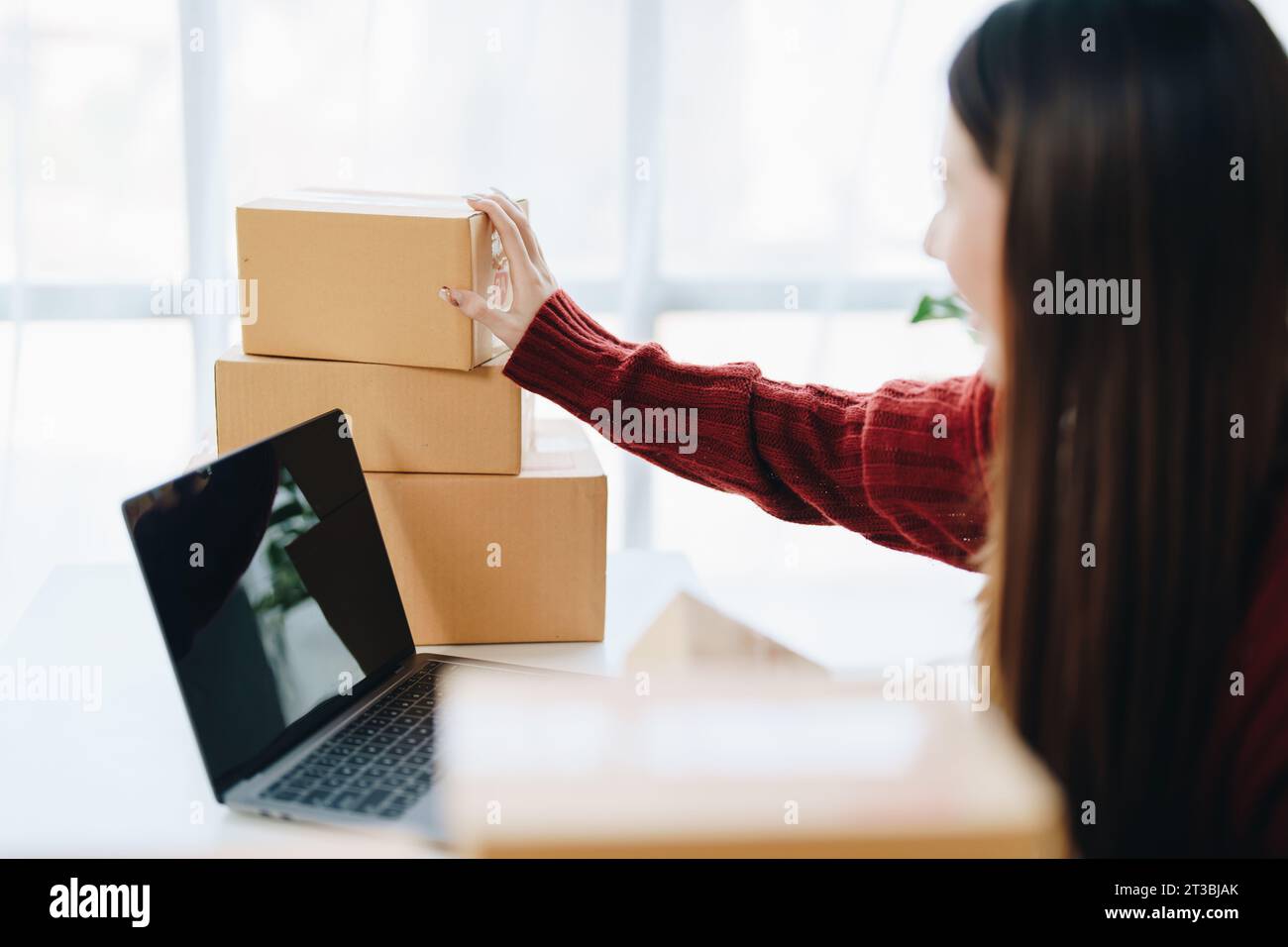 Asian female business owner handles delivery of orders to customers ...