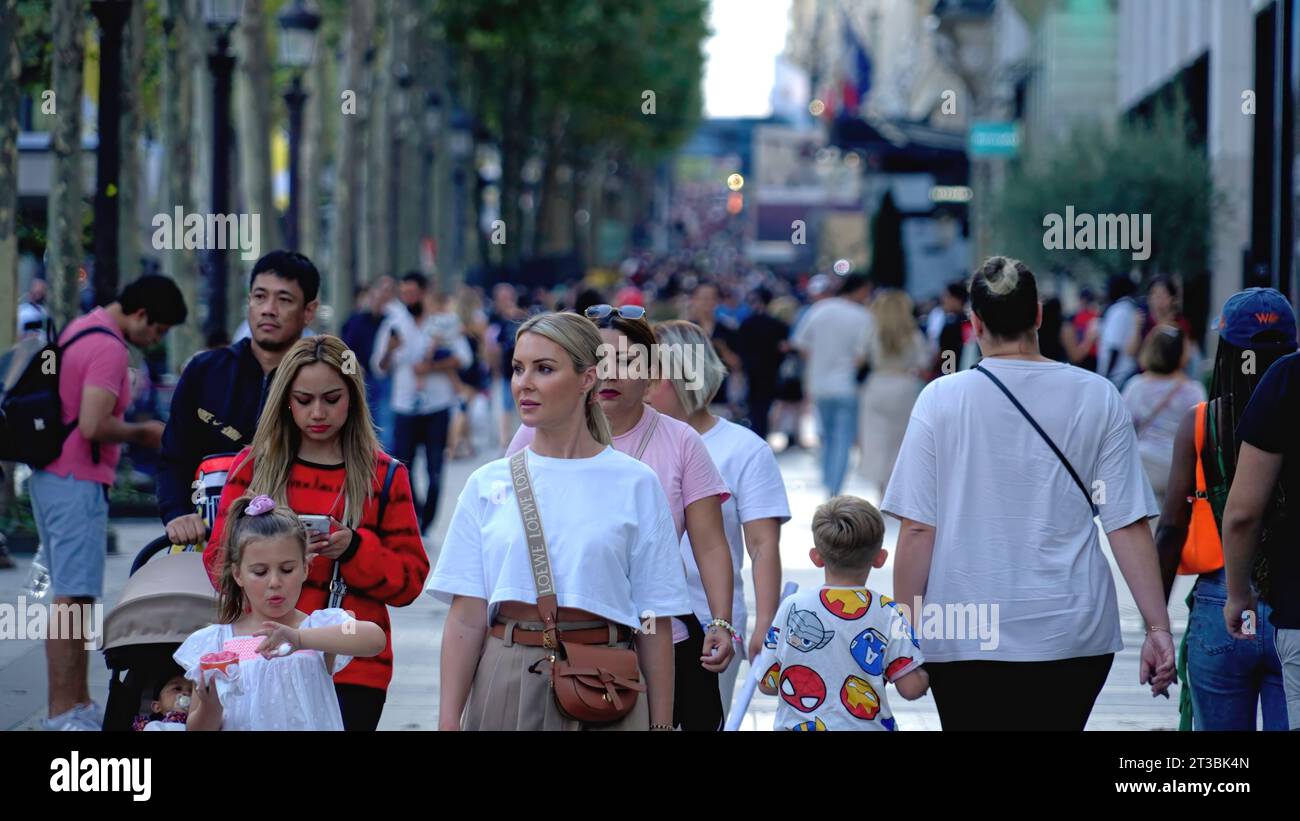 Large crowd of people walking on Champs-Elysee Avenue in Paris .- slow ...