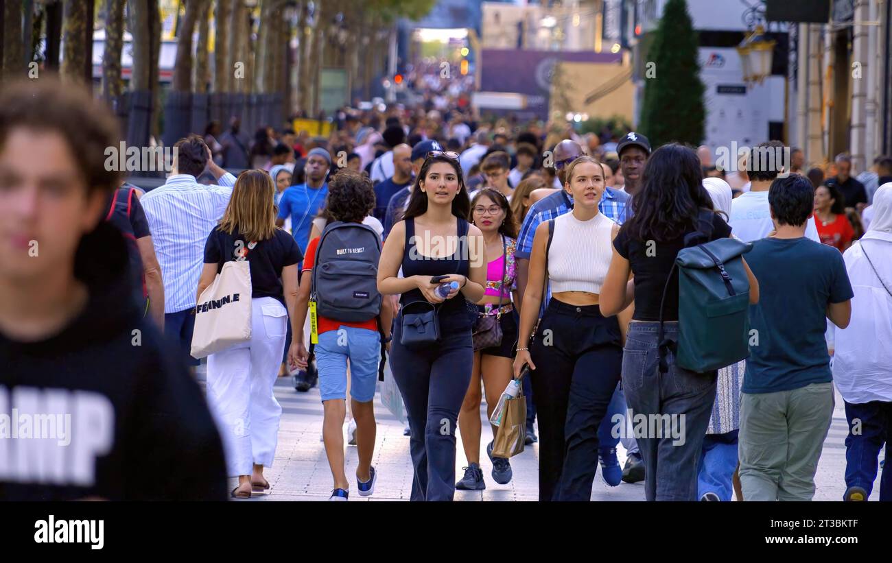 Large crowd of people walking on Champs-Elysee Avenue in Paris .- slow ...