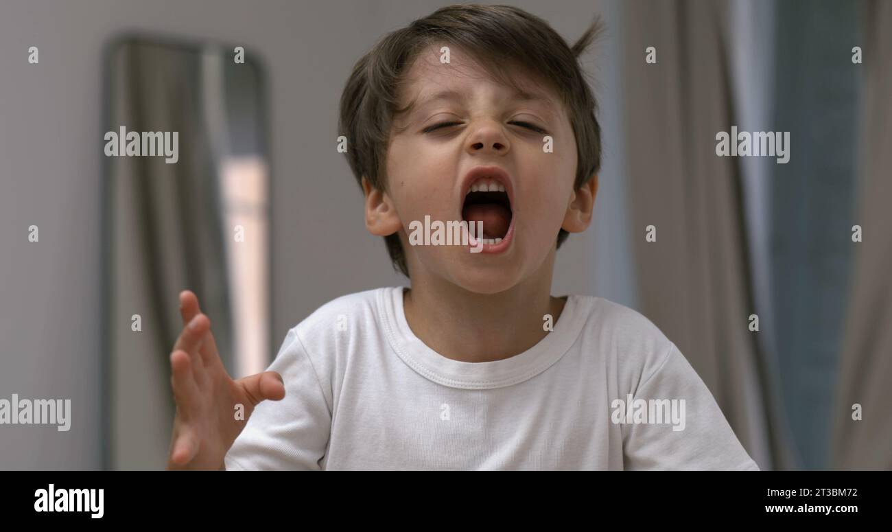 Angry child yelling and screaming at camera in super slow-motion. Upset ...