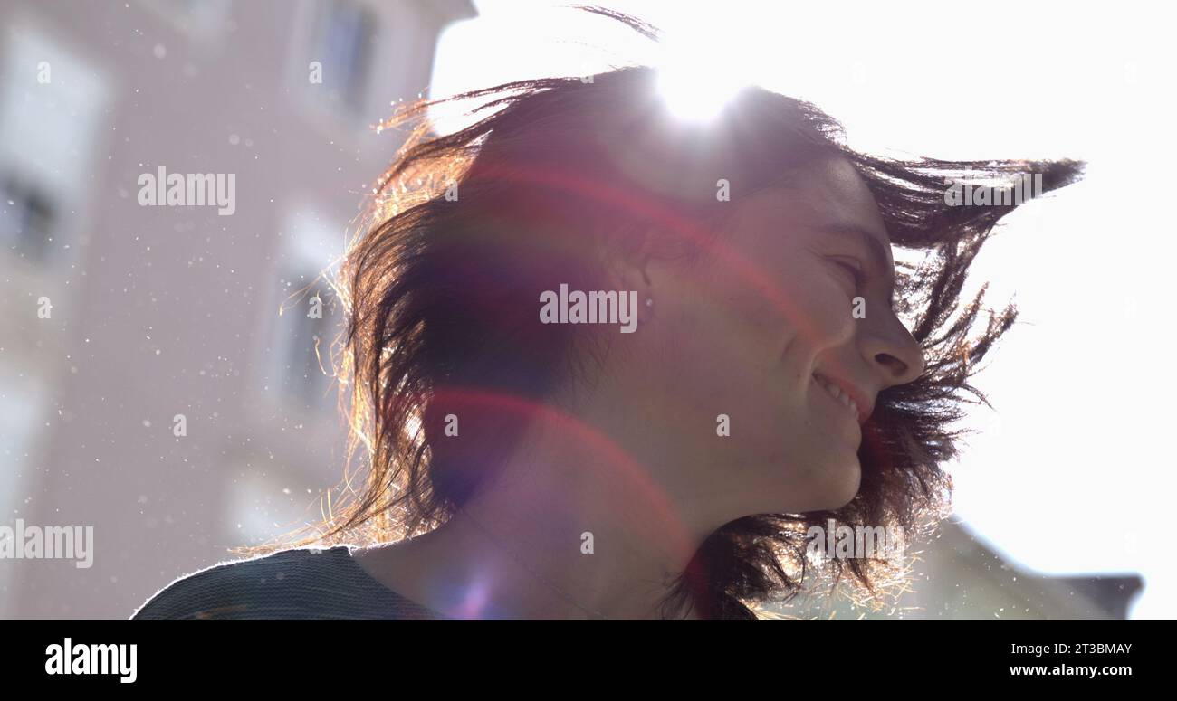Carefree woman shaking hair in super slow-motion outside in the ...