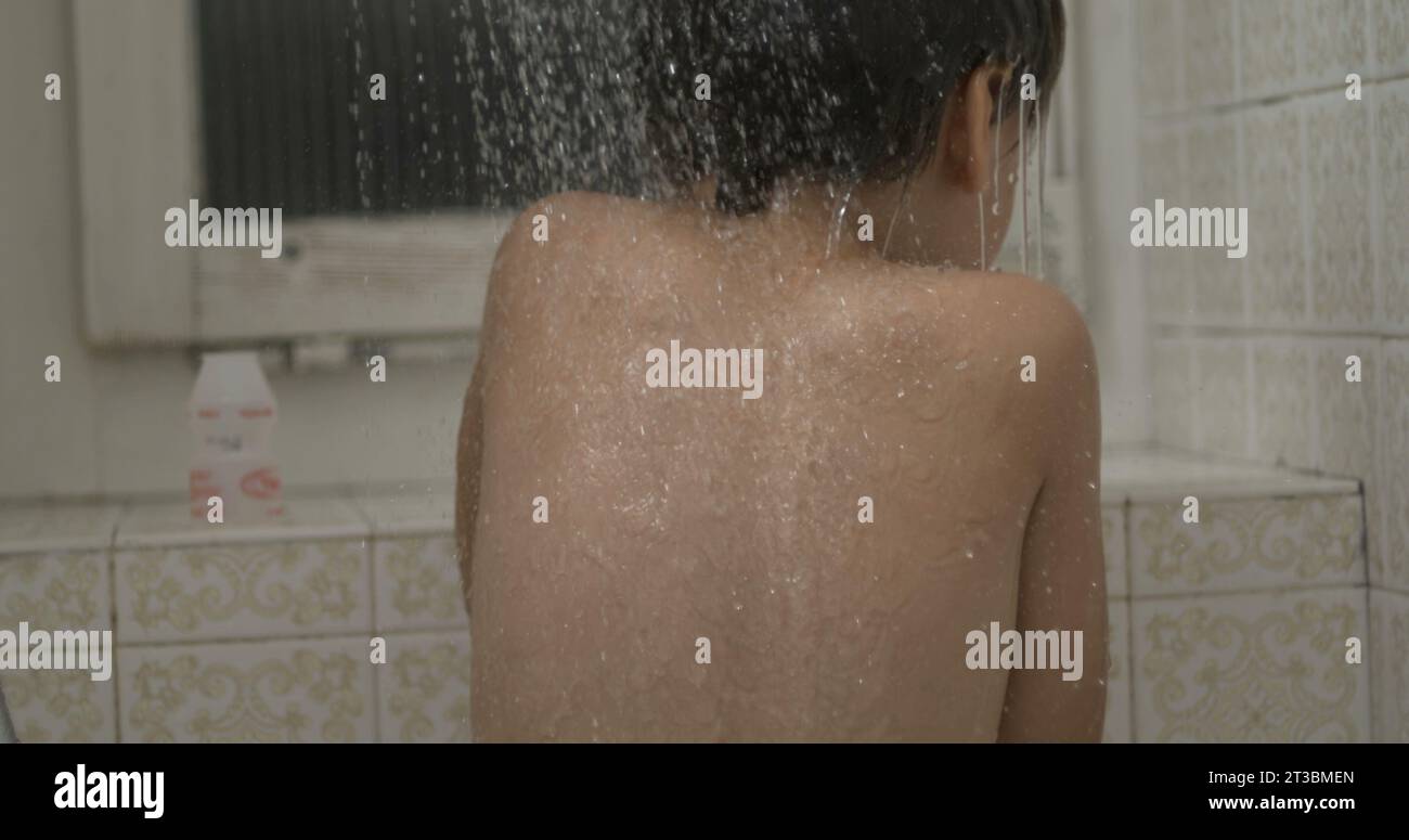 Child's back with water flow, 800 fps ultra slow-motion, under shower ...