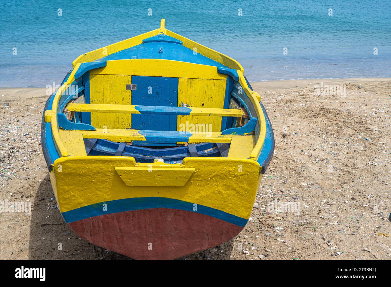 A photograph of brightly painted rowboat on a beach of Cape Verde Stock ...
