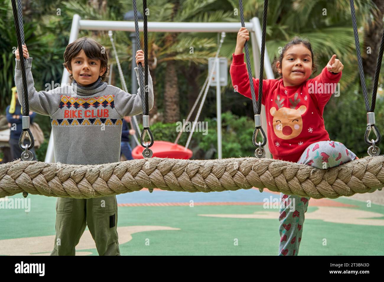 Multiethnic kids with Christmas sweaters excited to see the parade of ...