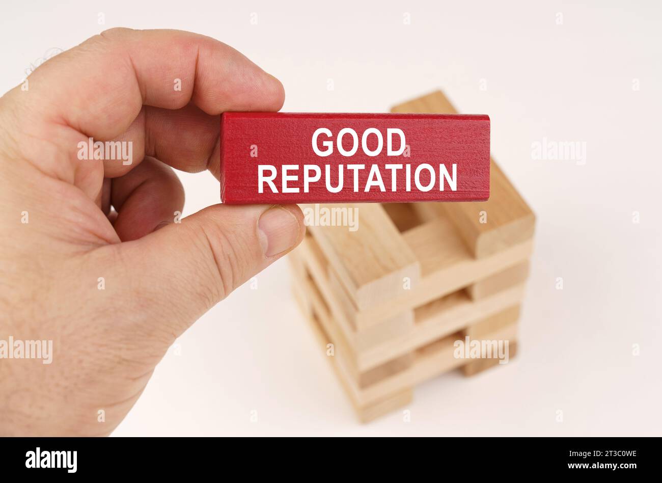 Business concept. In the hands of a man there is a red wooden plate ...