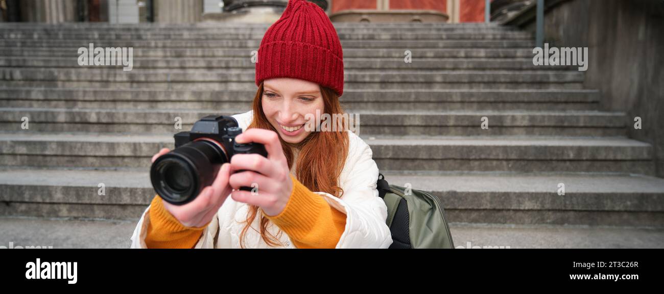 Portrait of young photographer girl, sits on stairs with professional ...