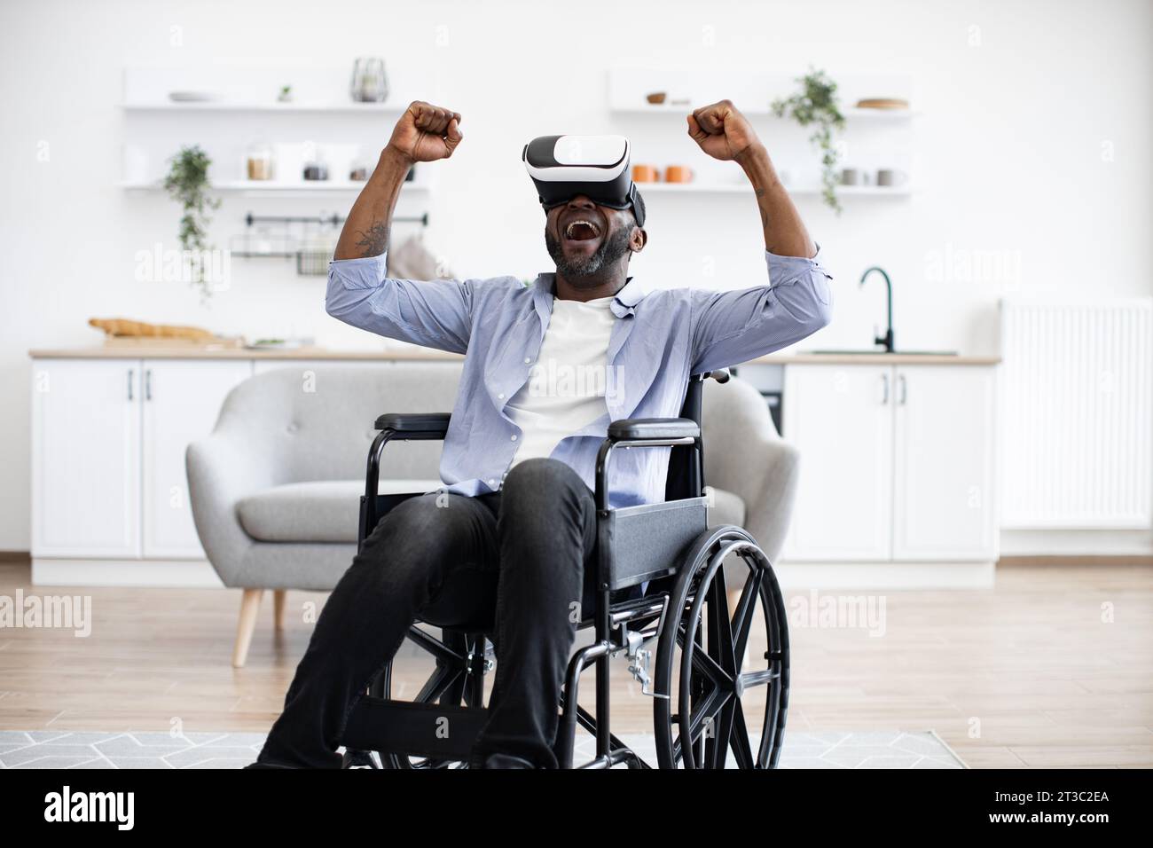 Smiling mature person with disability wearing VR headset and gesturing ...