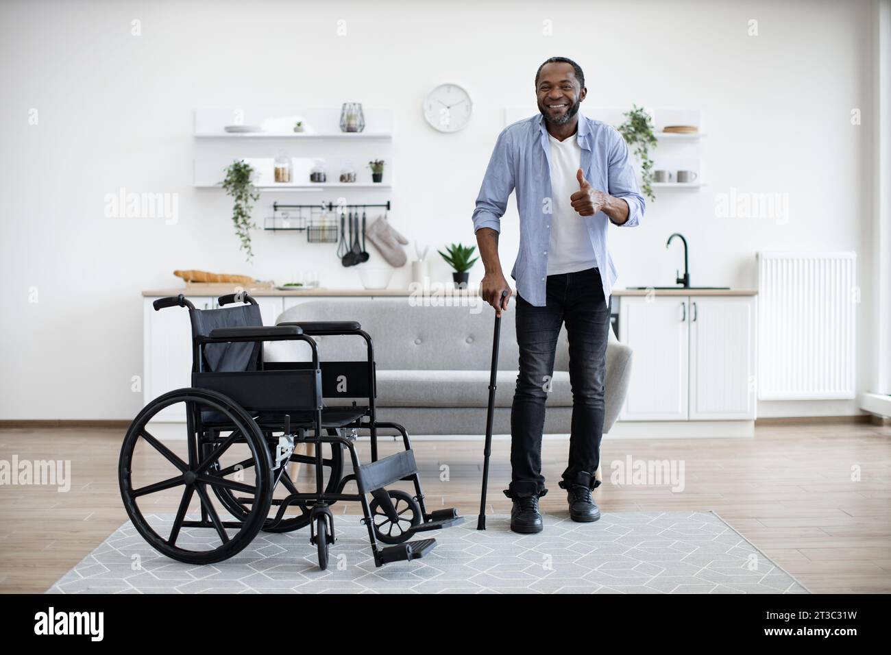 African man with disability using walking stick when raising from ...
