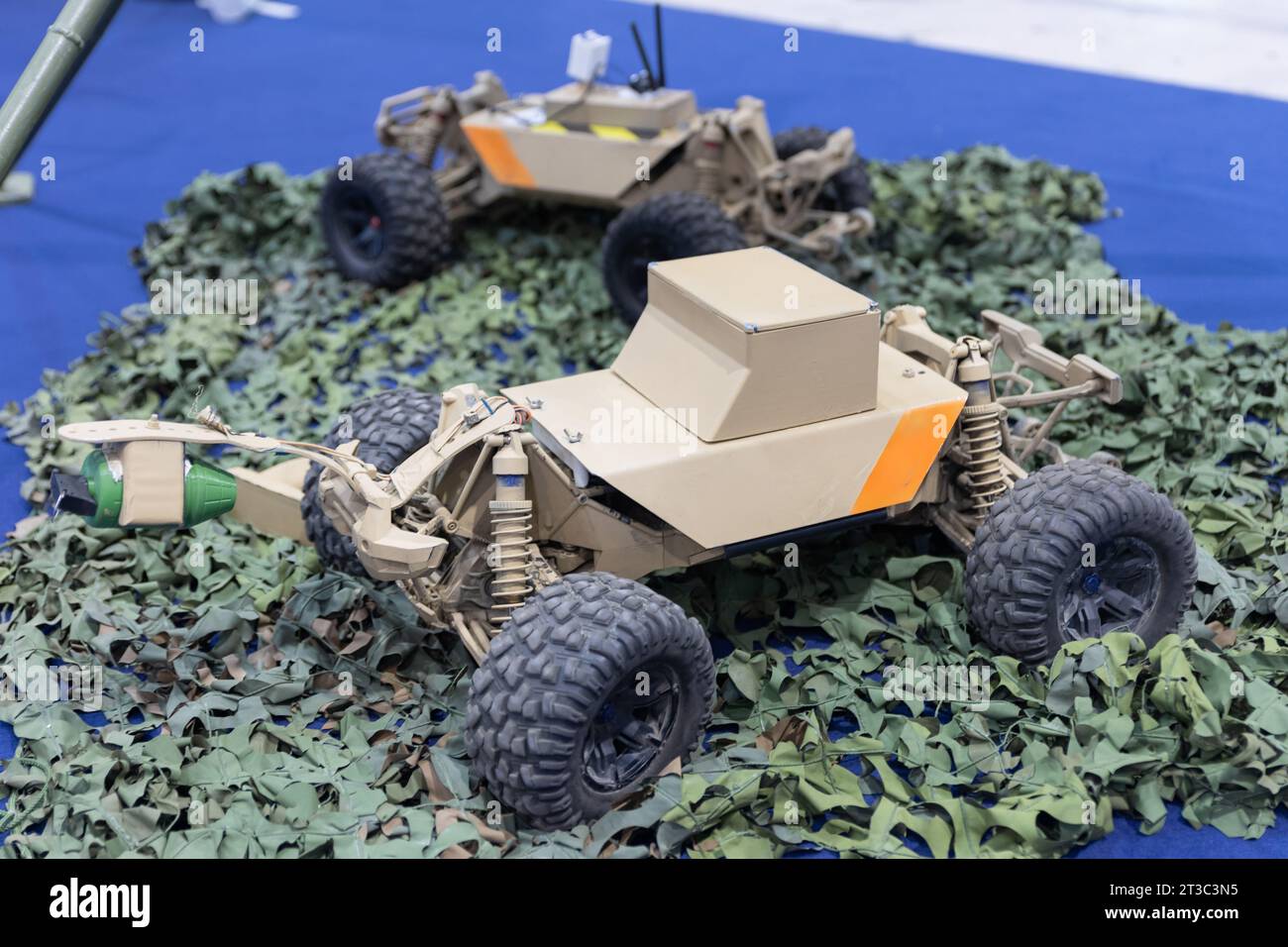 a military drone on a wheeled chassis with a grenade is a modern ...