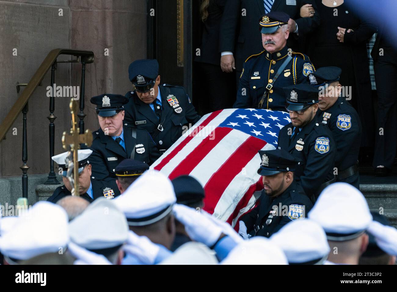 An honor guard carries the casket containing the remains of ...