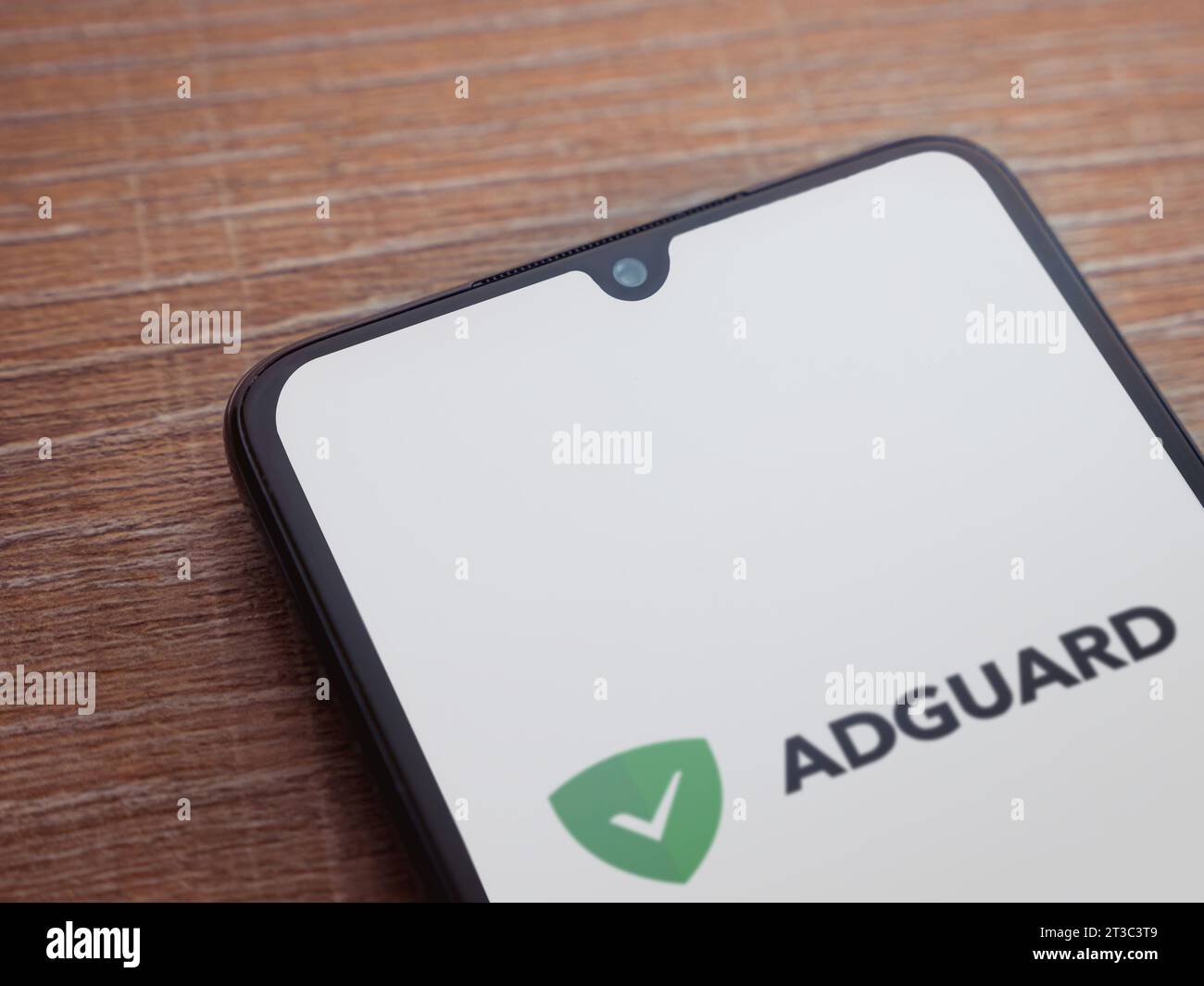 Lod, Israel - July 16,2023: AdGuard app launch screen on smartphone on wooden background. Top ...