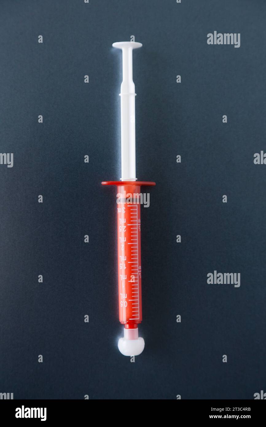 Syringe on dark background Stock Photo - Alamy