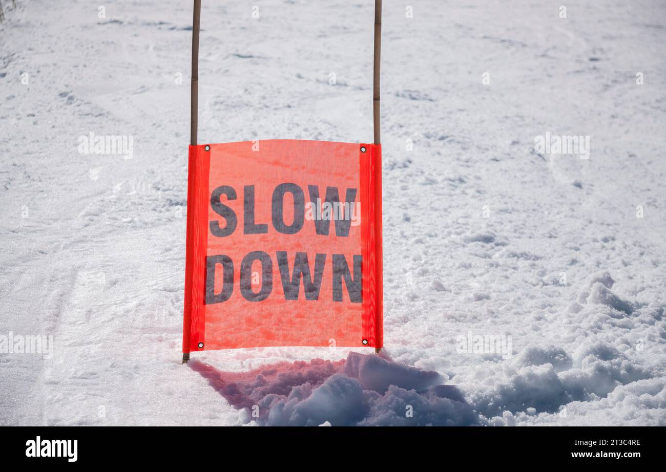 "Slow Down" sign on snowy hill Stock Photo - Alamy