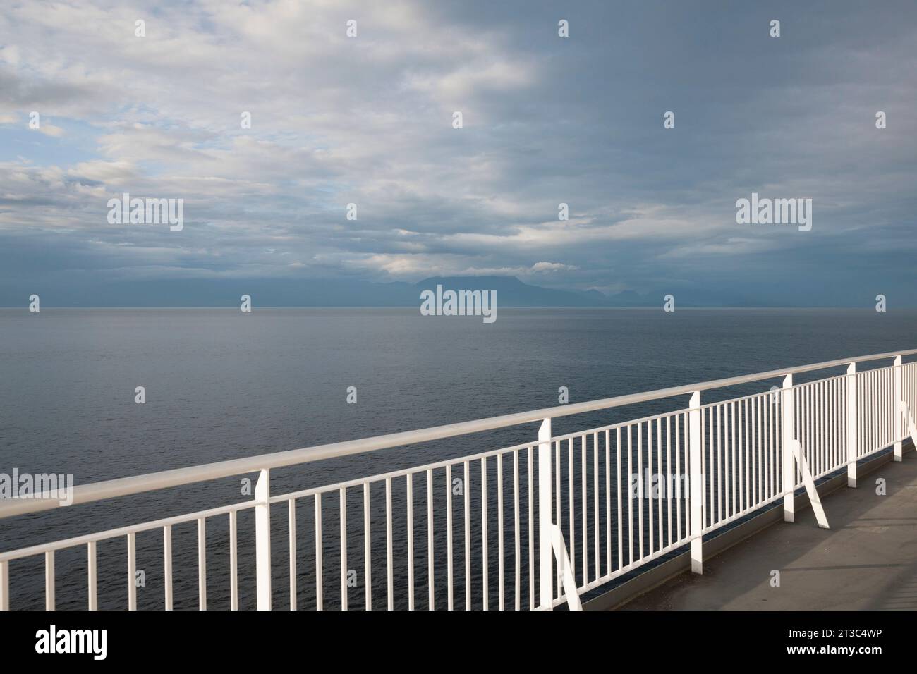 Ferry railing and ocean with mountains in background Stock Photo - Alamy