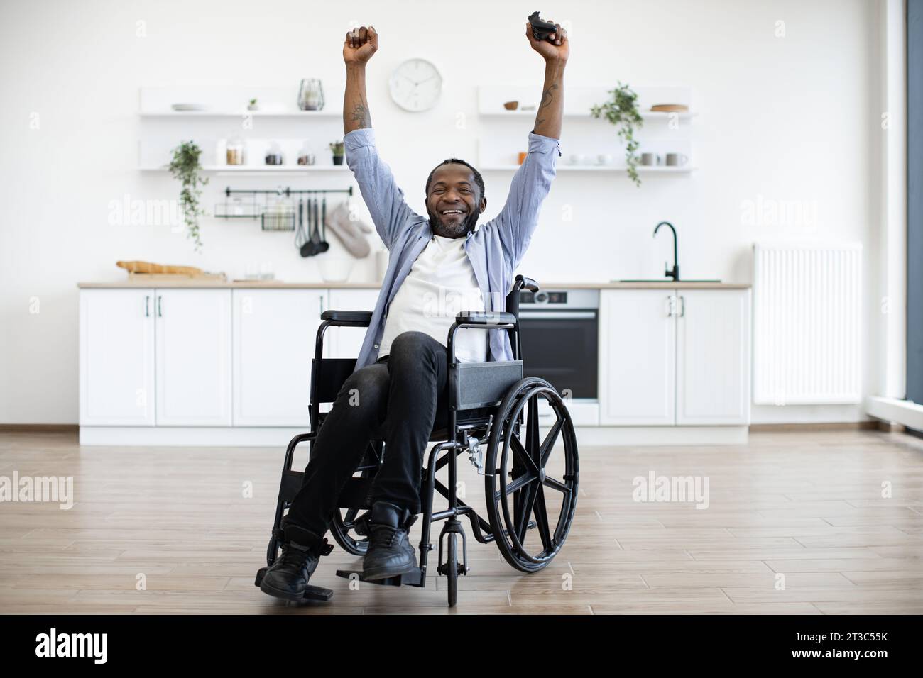 African person in wheelchair raising hands with joystick Stock Photo ...
