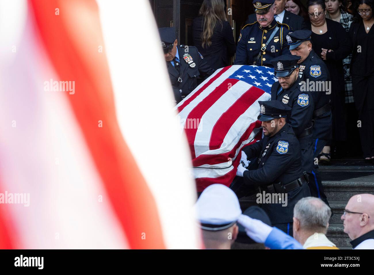 An honor guard carries the casket containing the remains of ...