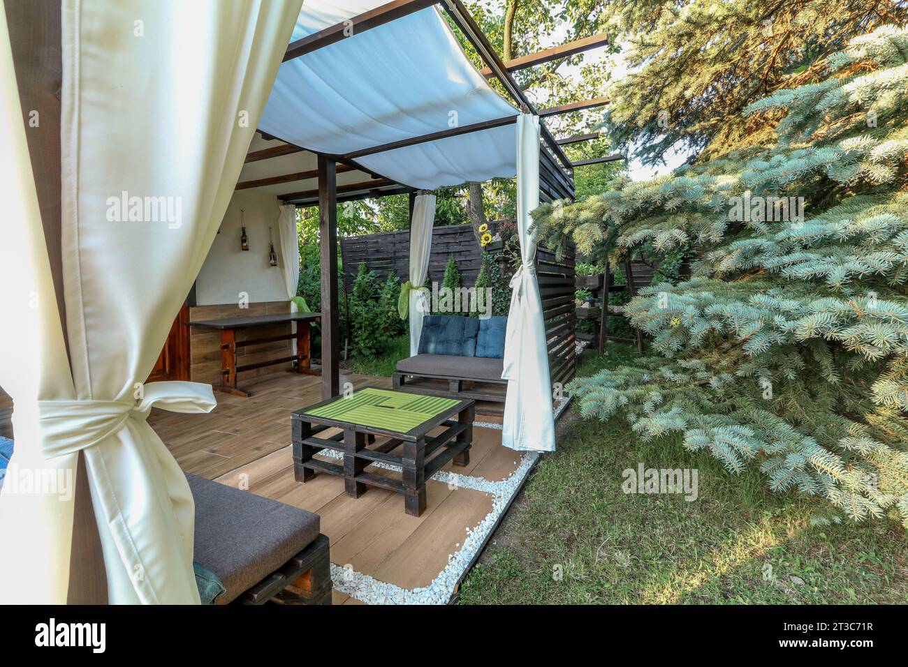 Laying terrace tiles in a gazebo on a recreation plot at summer Stock ...