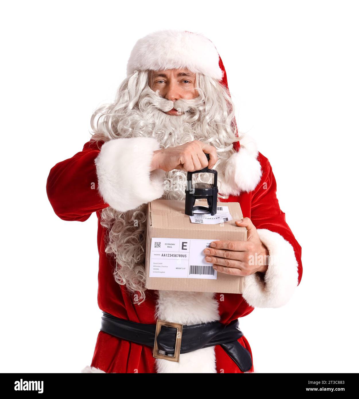 Santa Claus placing stamp on parcel against white background Stock ...