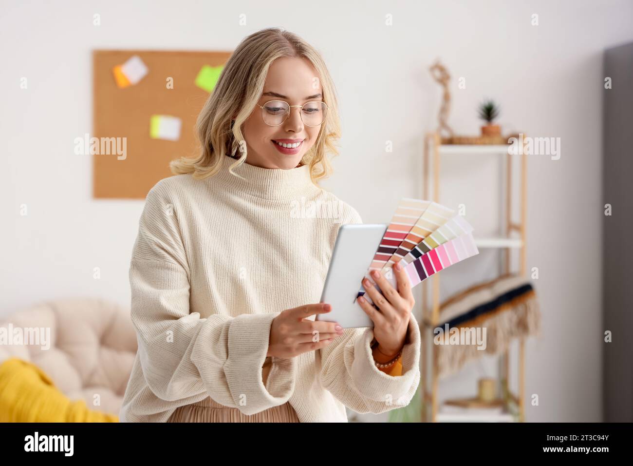 Female interior designer with tablet computer and color palettes in ...