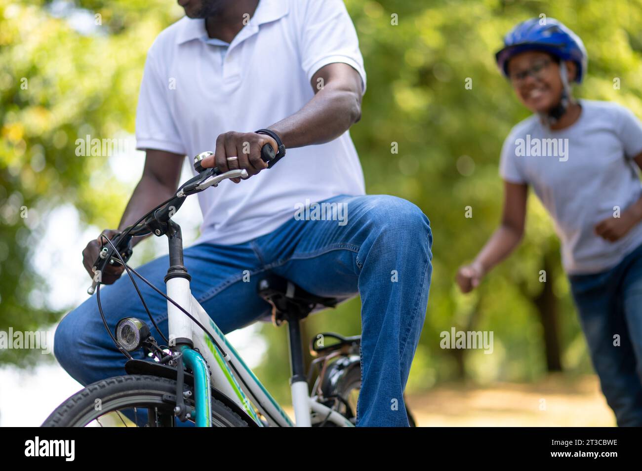 African american man riding a bike and having fun with his kids Stock ...
