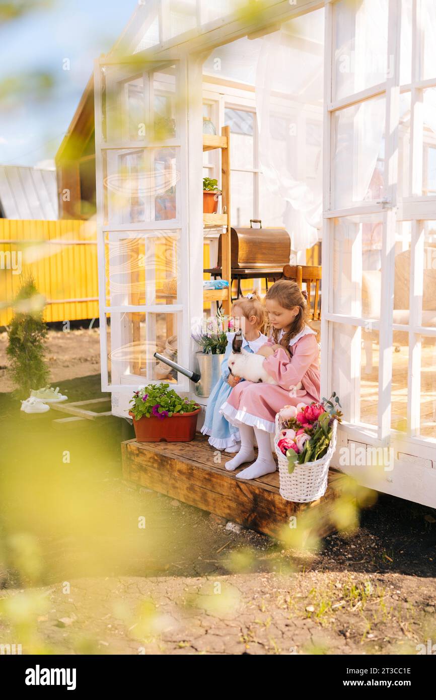 Remote view of two adorable little sisters in beautiful dress hugging ...