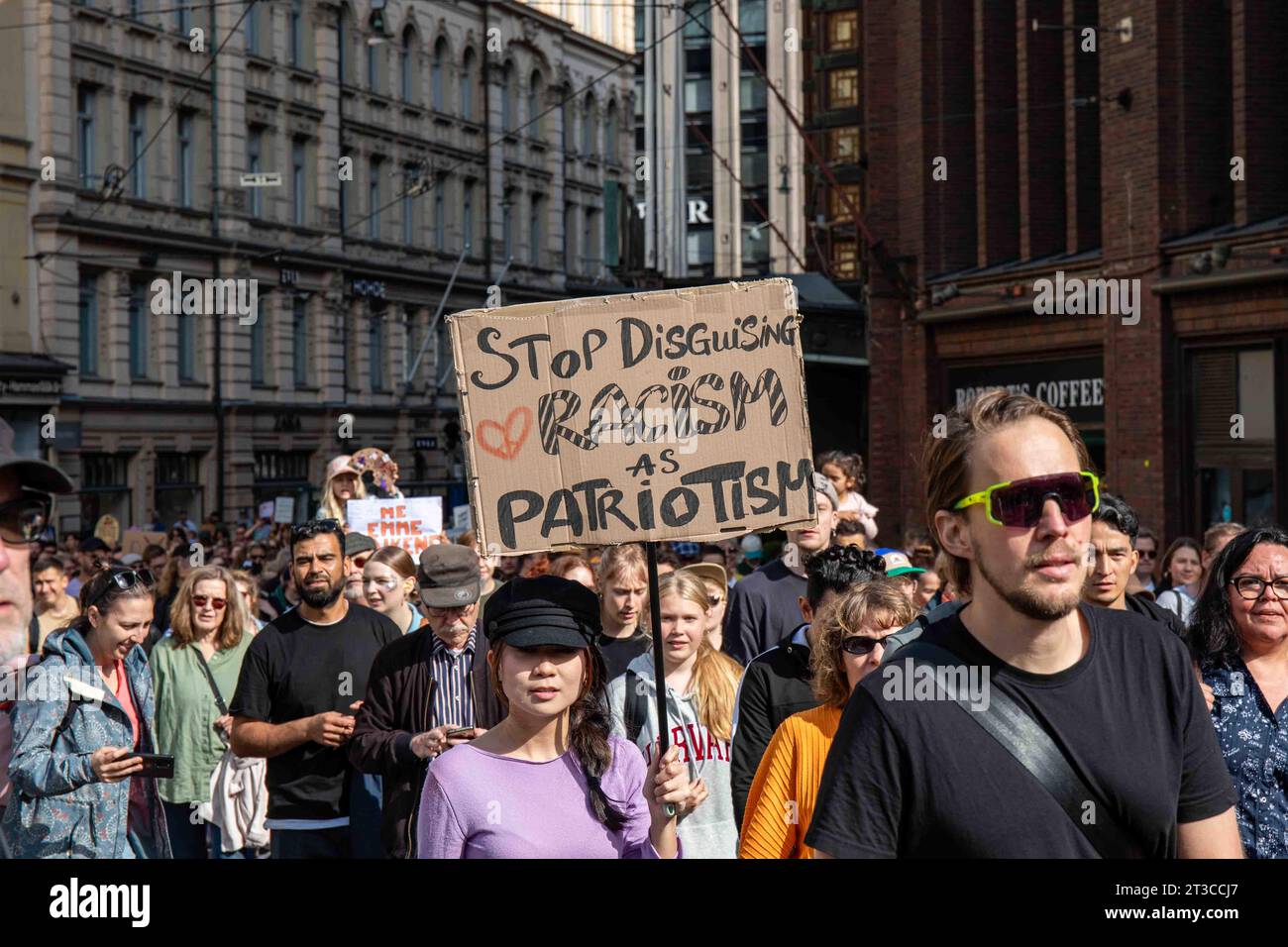 Stop Disguising Racism as Patriotism. Protester holding a cardboard ...