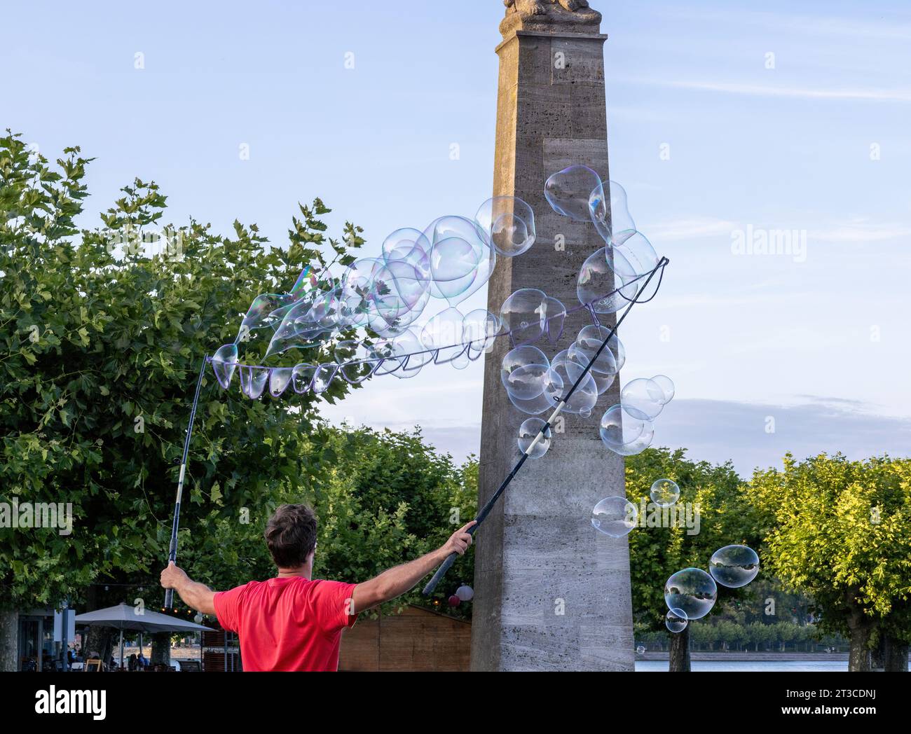 Man makes lots of soap bubbles with a special string Stock Photo - Alamy