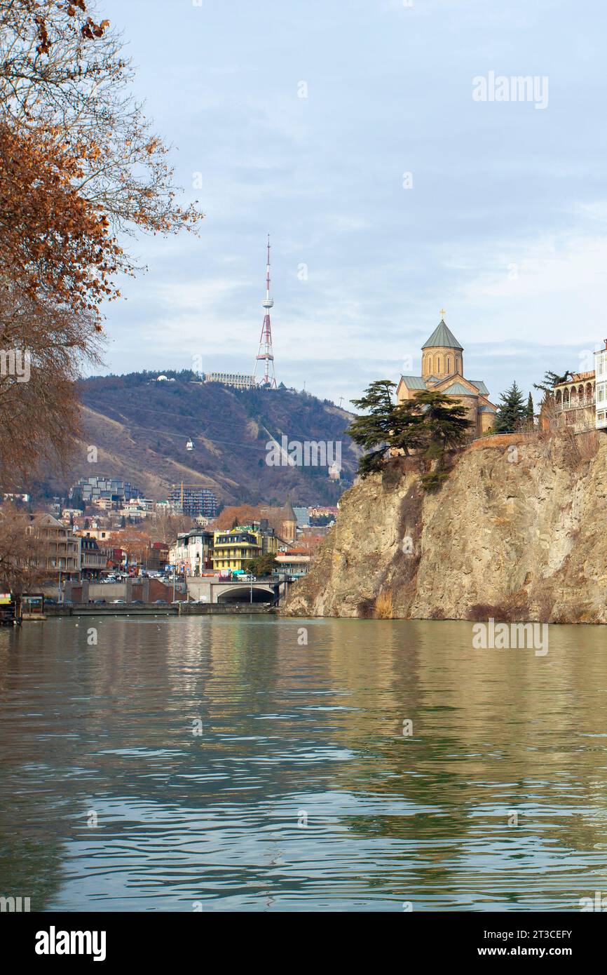 Metekhi church and Houses on the edge of a cliff above the river Kura ...