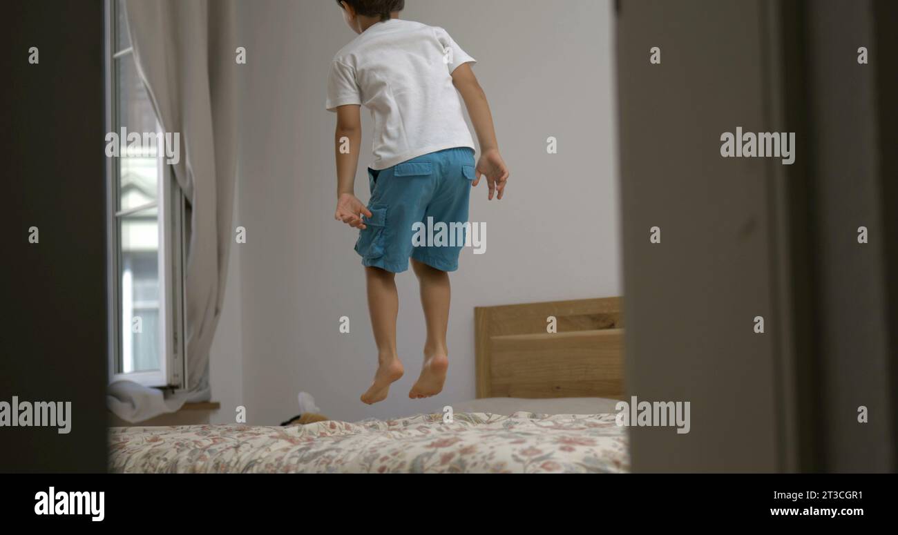 Little boy in pure joy leaping on bed in 1000 fps. Euphoric emotion of ...