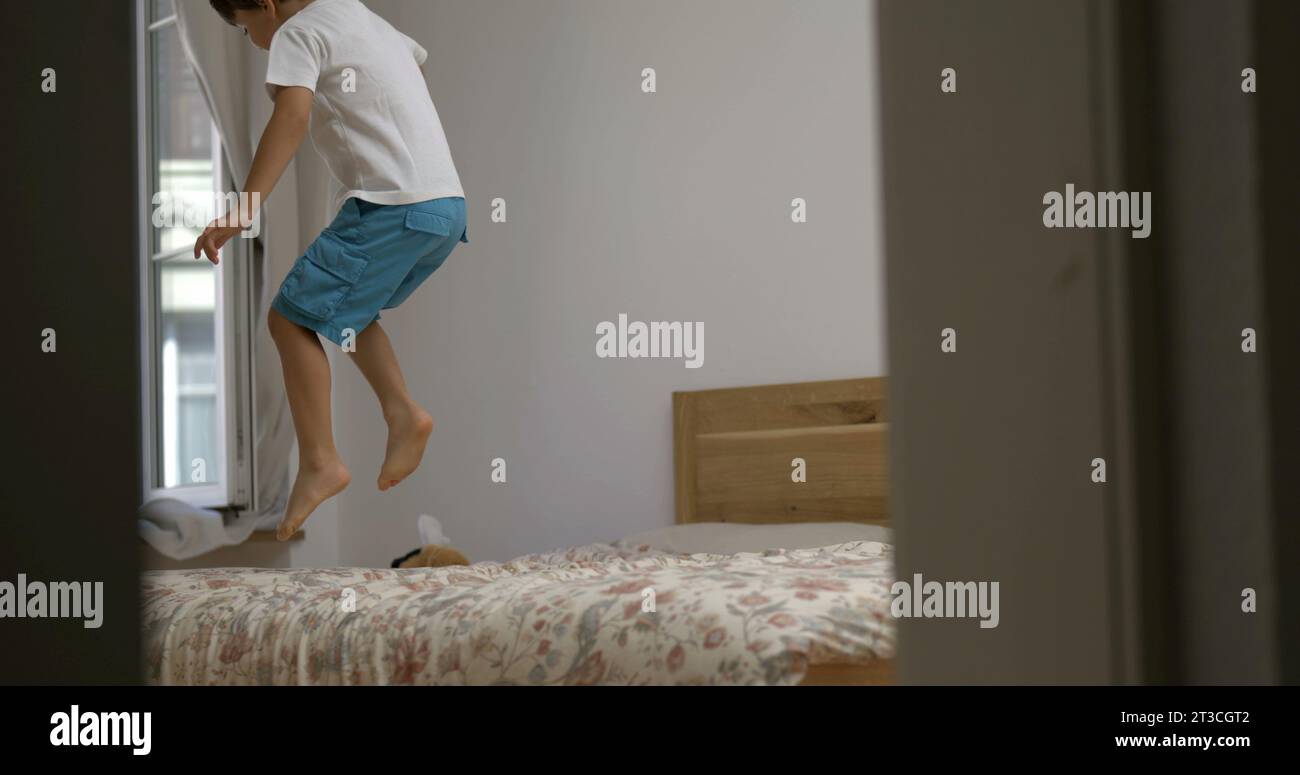 Little boy in pure joy leaping on bed in 1000 fps. Euphoric emotion of ...