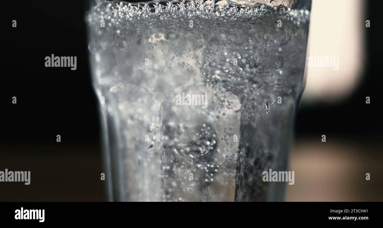 Serving sprinkling water into transparent glass cup in 800 fps slow ...