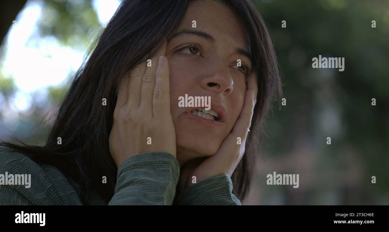 Stressed woman feeling anxiety and distress while rubbing face in slow ...