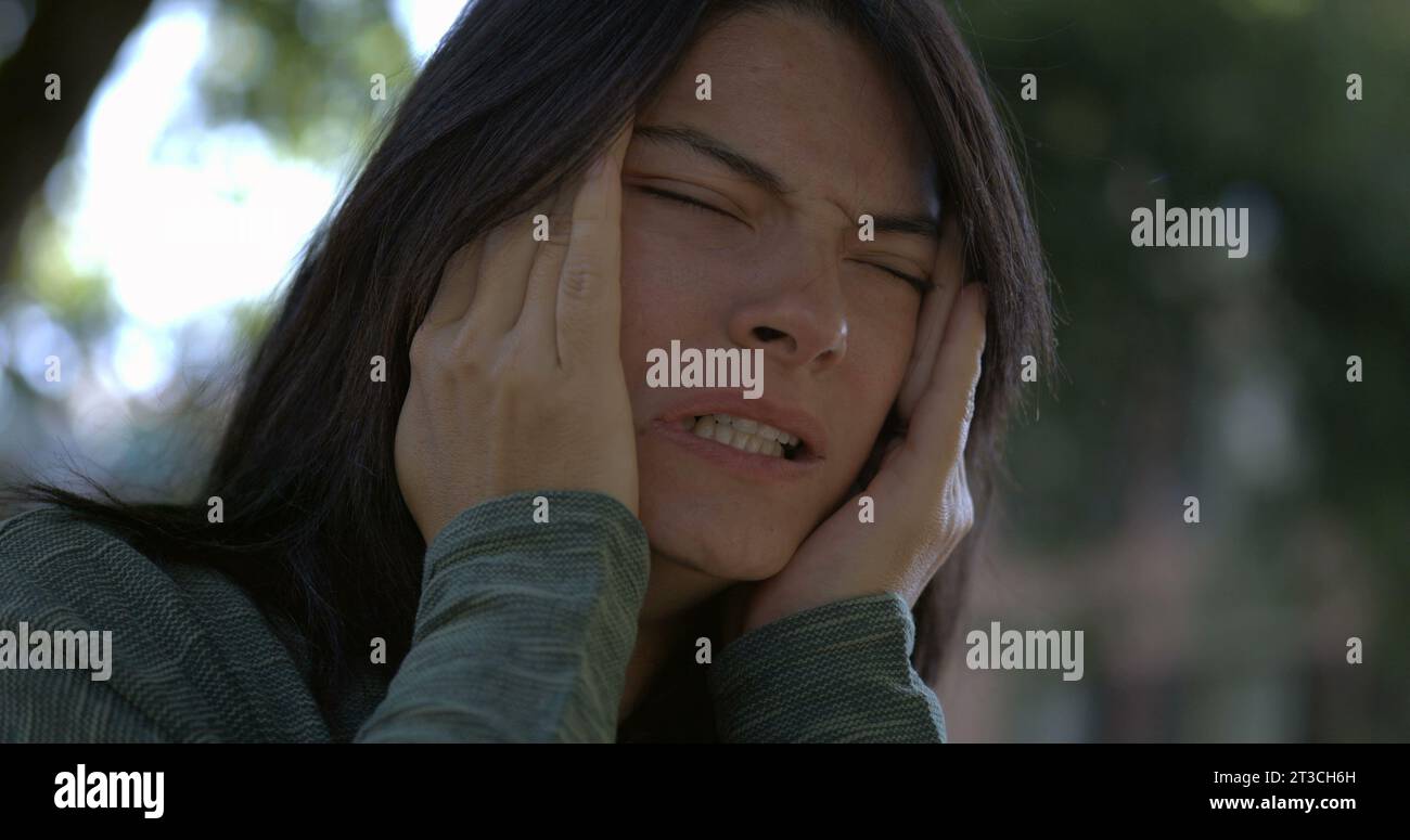 Stressed woman feeling anxiety and distress while rubbing face in slow ...