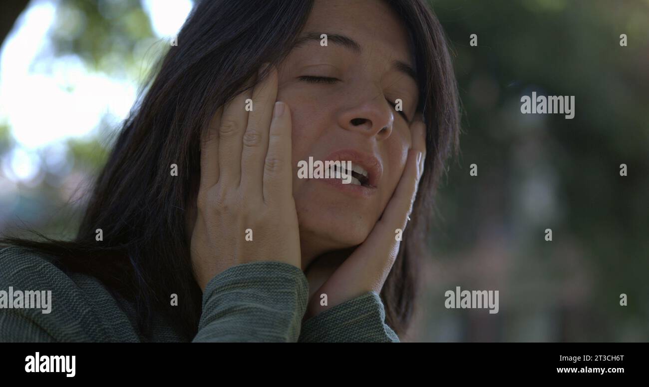 Stressed woman feeling anxiety and distress while rubbing face in slow ...