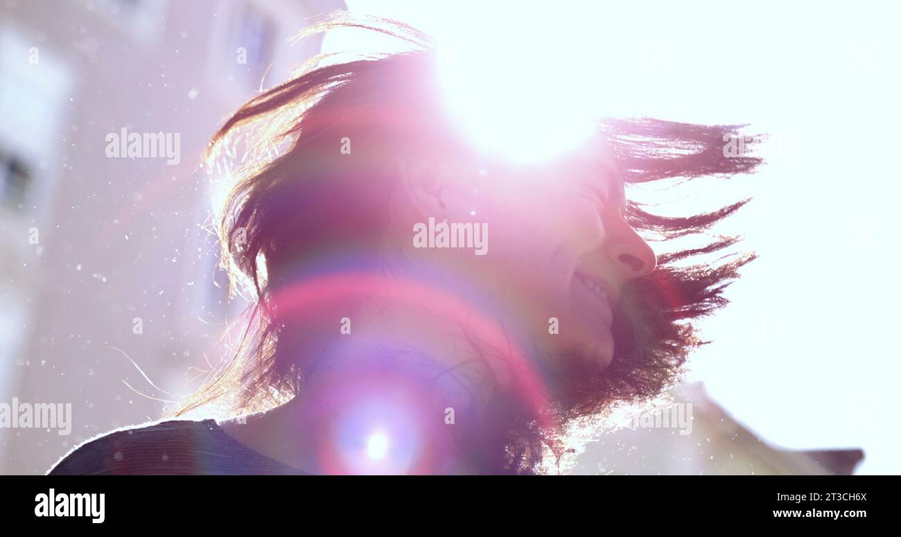 Sunlit Slow-Motion of 30s Woman Shaking Hair with Flare Stock Photo - Alamy