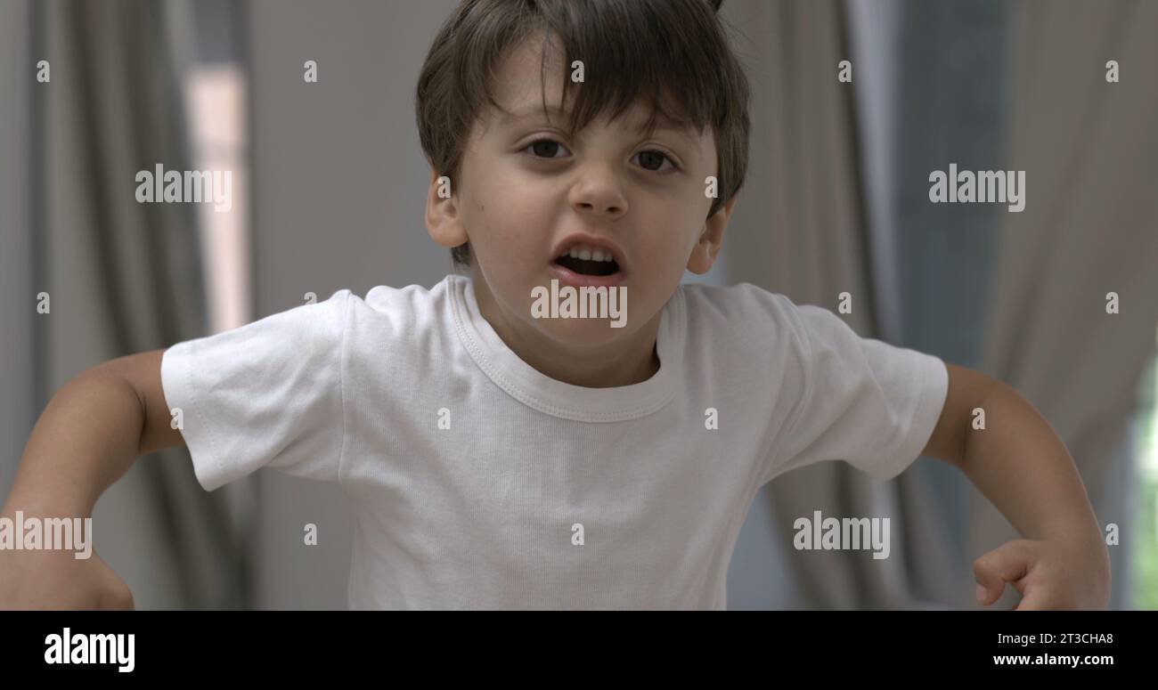 Upset child emotion in slow-motion. Close-up of angry little boy ...