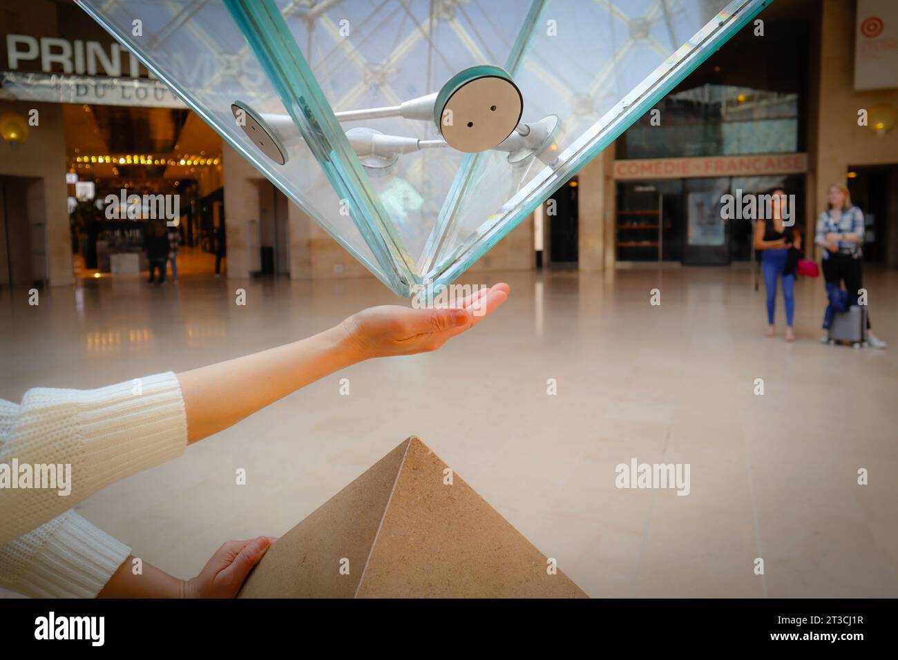 Louvre Museum, Paris, France. Hand under Louvre inverted pyramid ...
