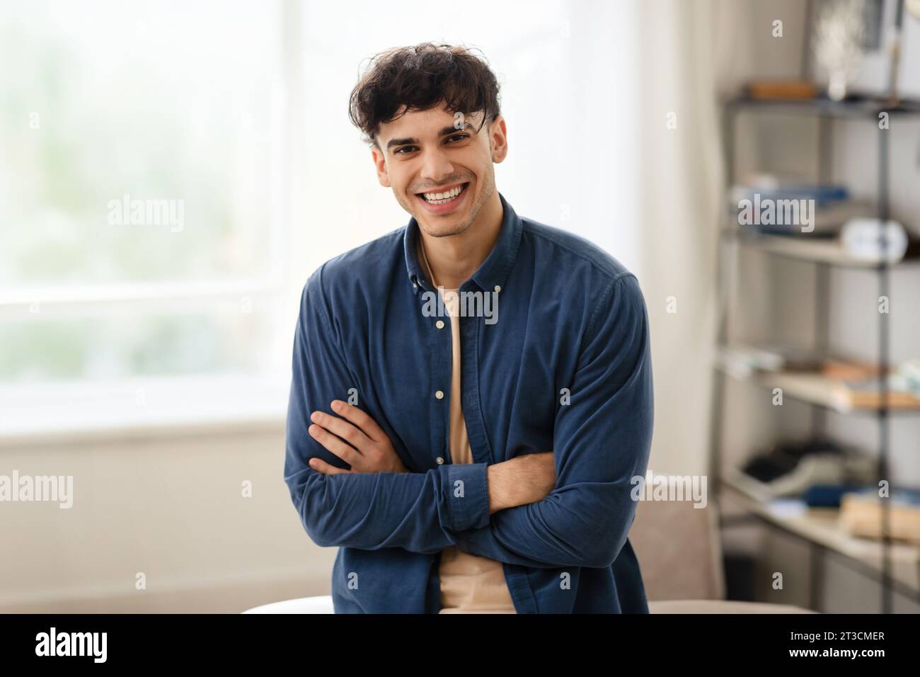 Arabic Guy Standing With Folded Arms Near Desk At Home Stock Photo - Alamy