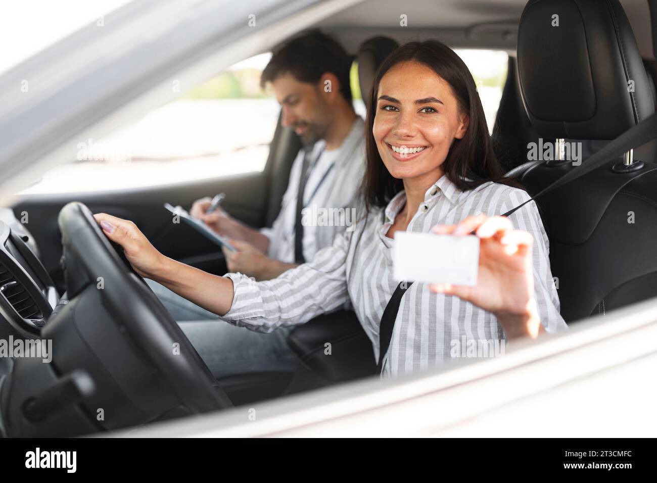 Young Woman Showing Her Driving License, Sitting In Car Stock Photo - Alamy