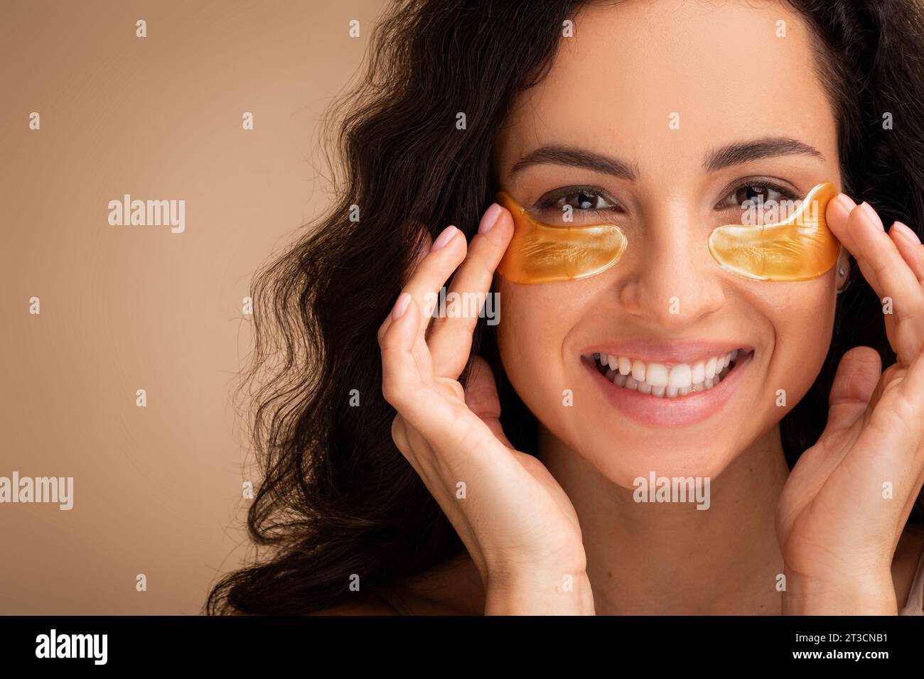 Happy millennial indian woman applying eye patches Stock Photo - Alamy