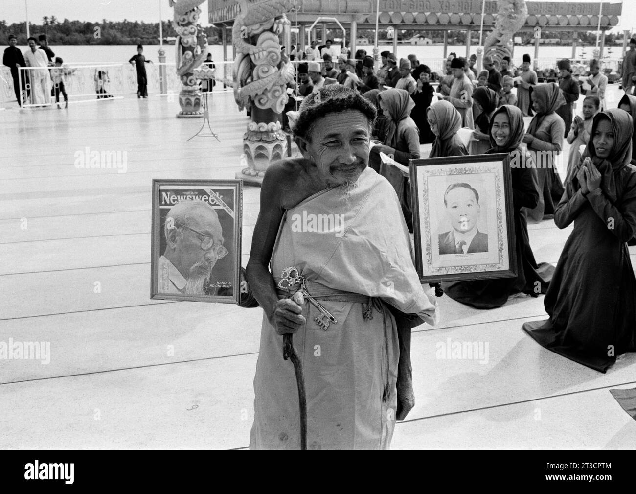 Nguyen Thanh Nam, known as the "Coconut Monk," walks past his disciples ...