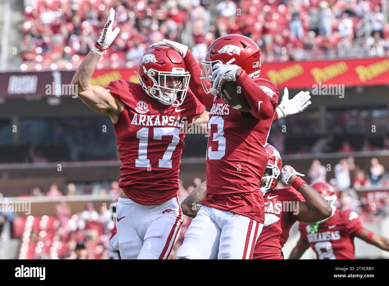 Arkansas defensive back Alfahiym Walcott, right, celebrates with ...