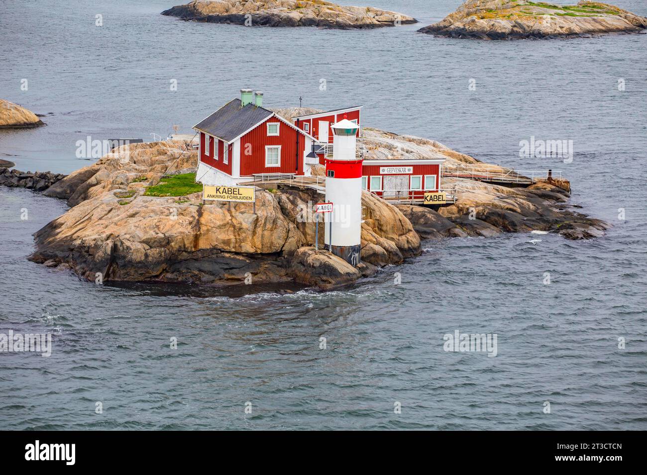 Typical tiny archipelago island with lighthouse and lighthouse keeper's ...