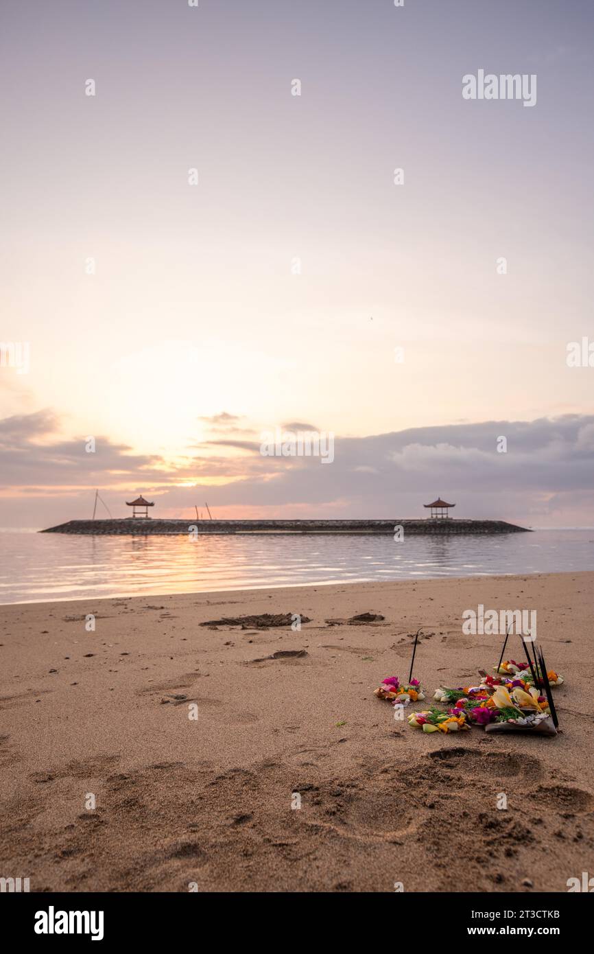 Sunrise on a sandy beach with small temples in the water. Landscape ...