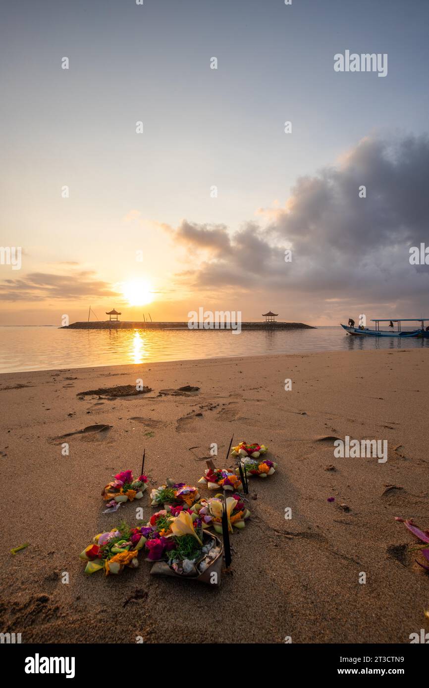 Sunrise on a sandy beach with small temples in the water. Landscape ...