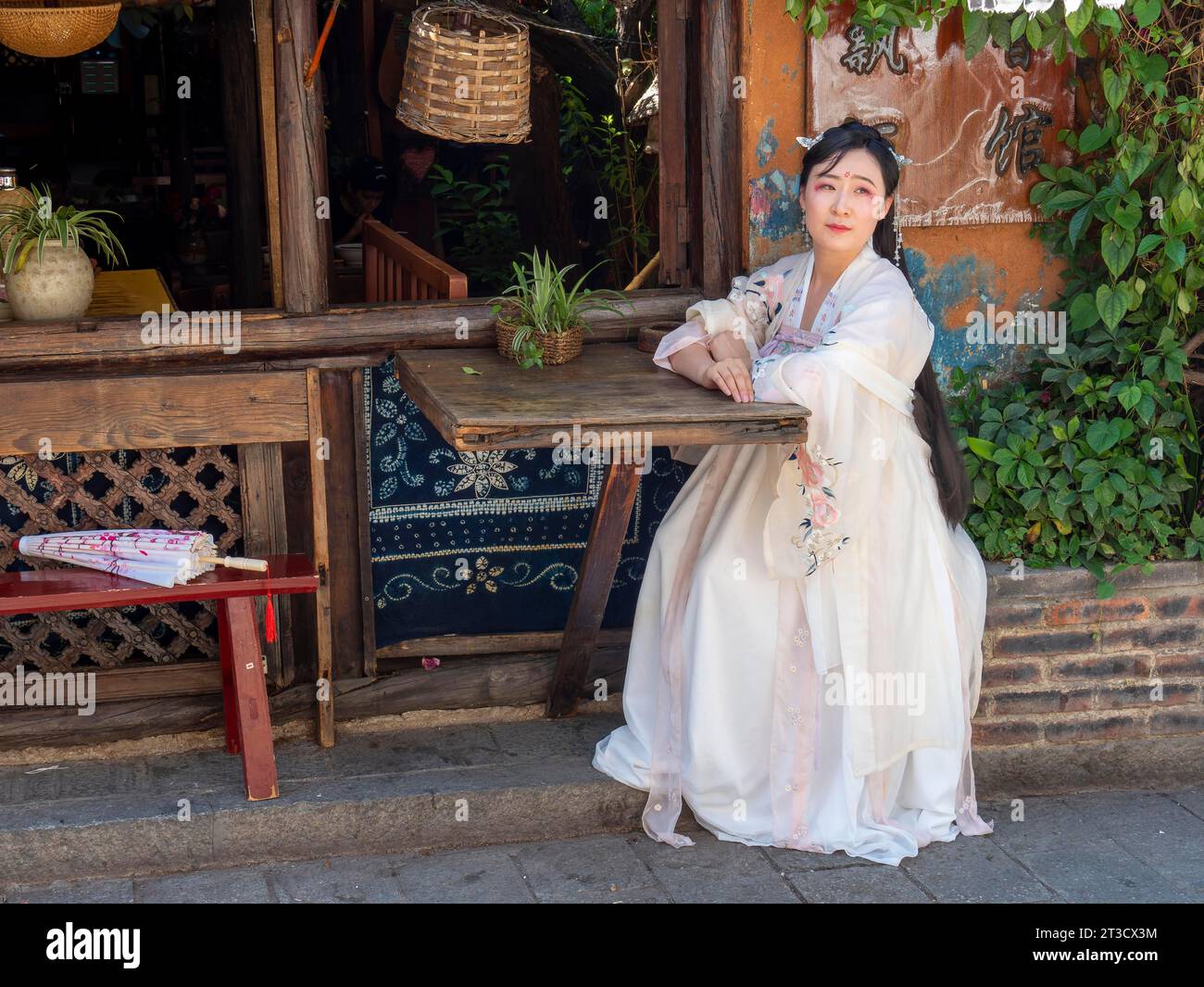 Woman in Chinese nostalgia with old luxurious white dress in front of ...