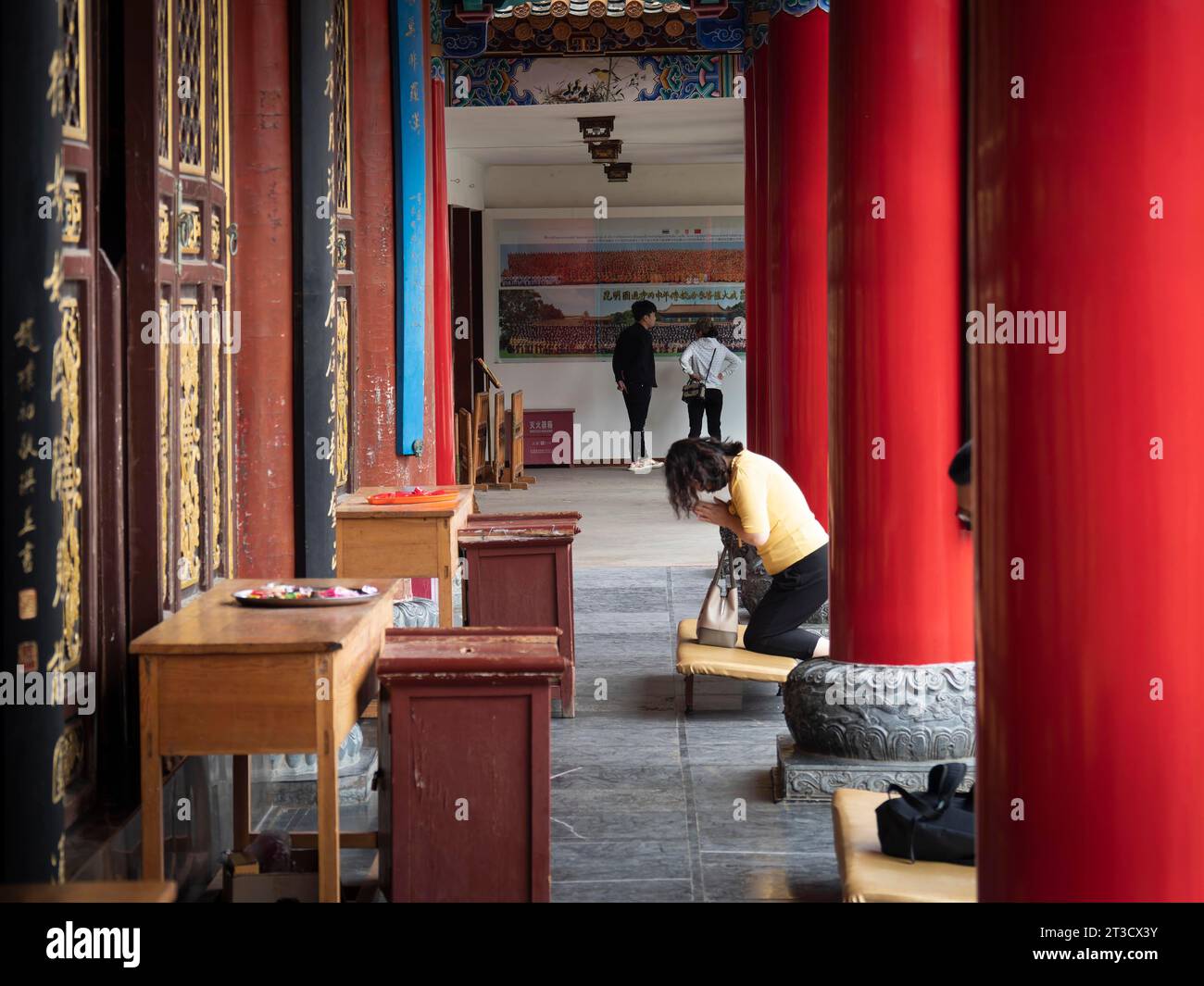 Red columns, praying people, Yuantong Temple, Kunming, Yunnan, China ...