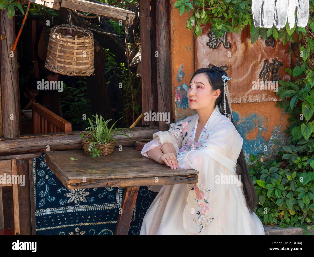 Woman in Chinese nostalgia with old luxurious white dress in front of ...